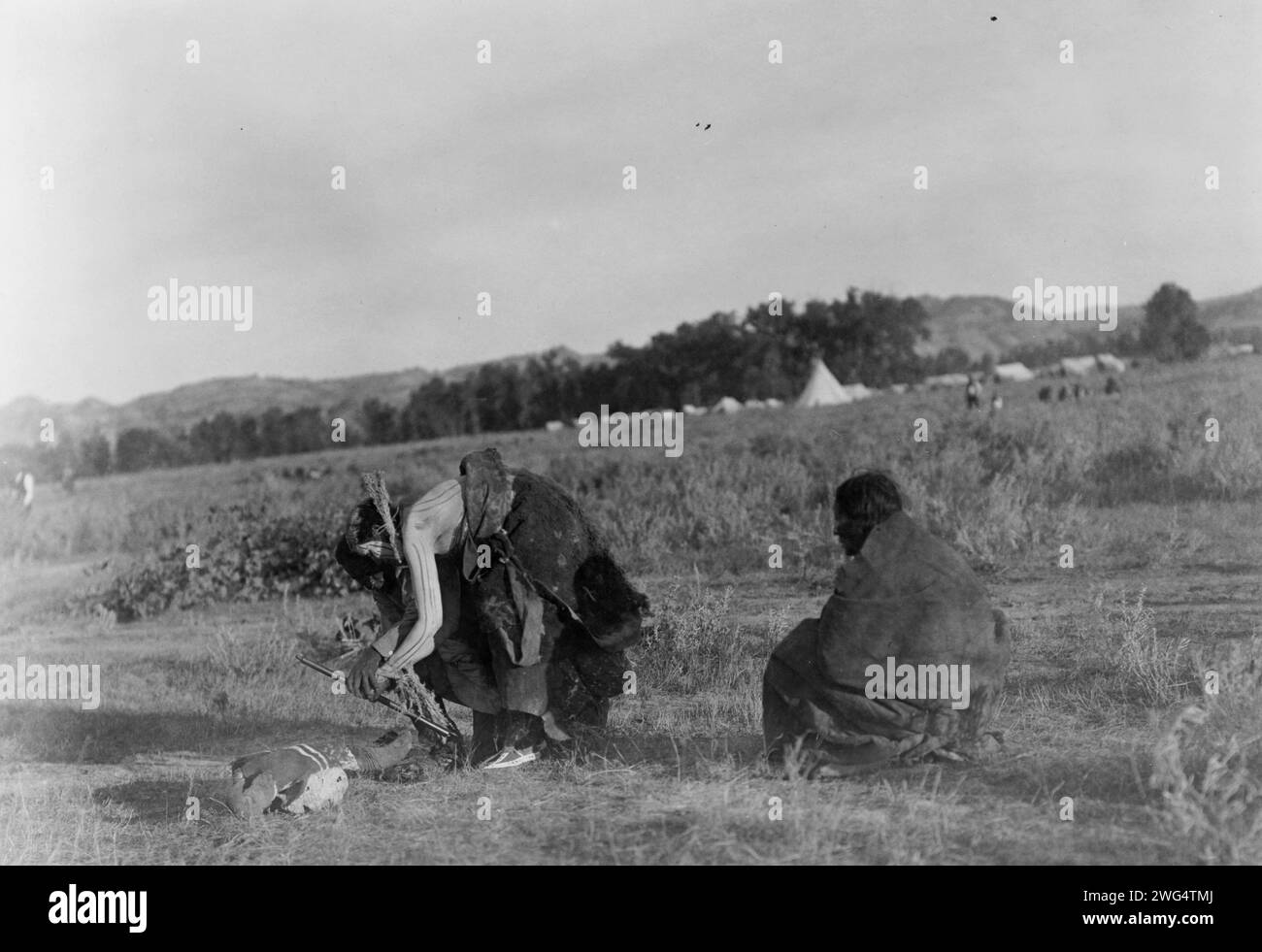 Offering pipe to the skull-Cheyenne, c1910. Woman offering pipe to ...