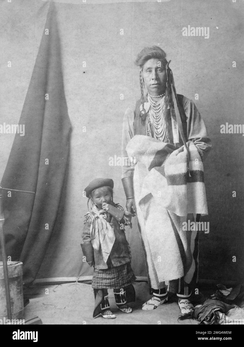 Strong Enemy, c1908. Full-length portrait of Crow man and child Stock ...