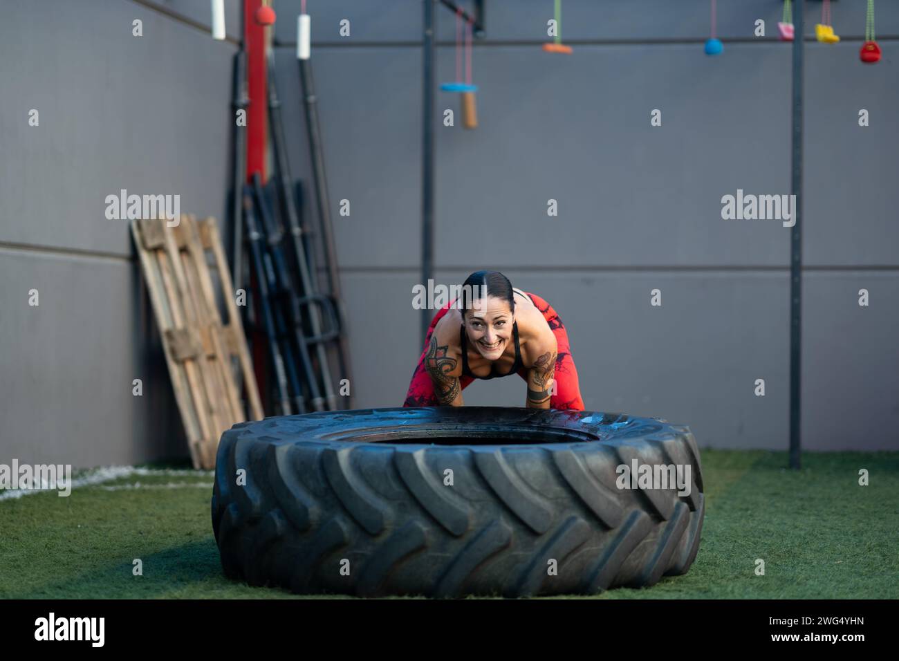 Sportive woman flipping a huge wheel in the gym Stock Photo - Alamy