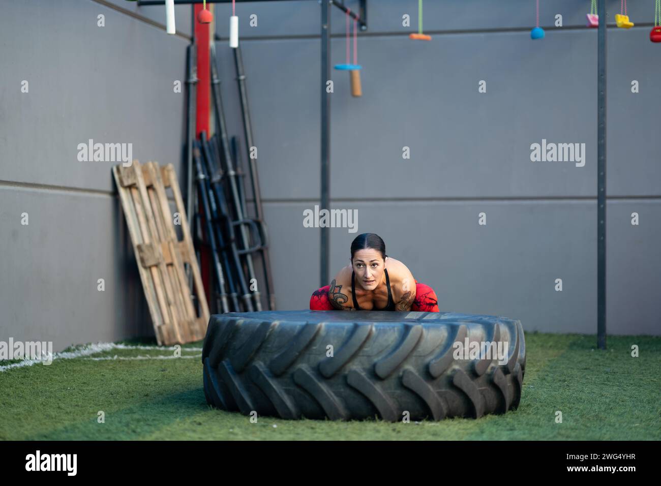 Strong woman working out with a wheel in a gym Stock Photo - Alamy