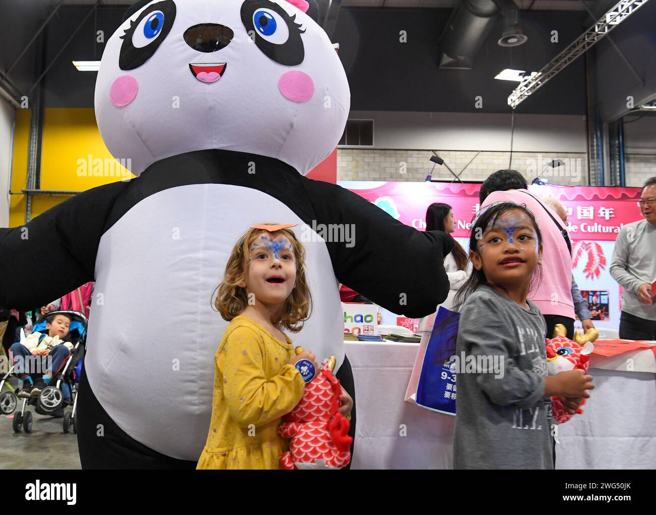 Auckland, New Zealand. 3rd Feb, 2024. Children walk past a panda figure ...
