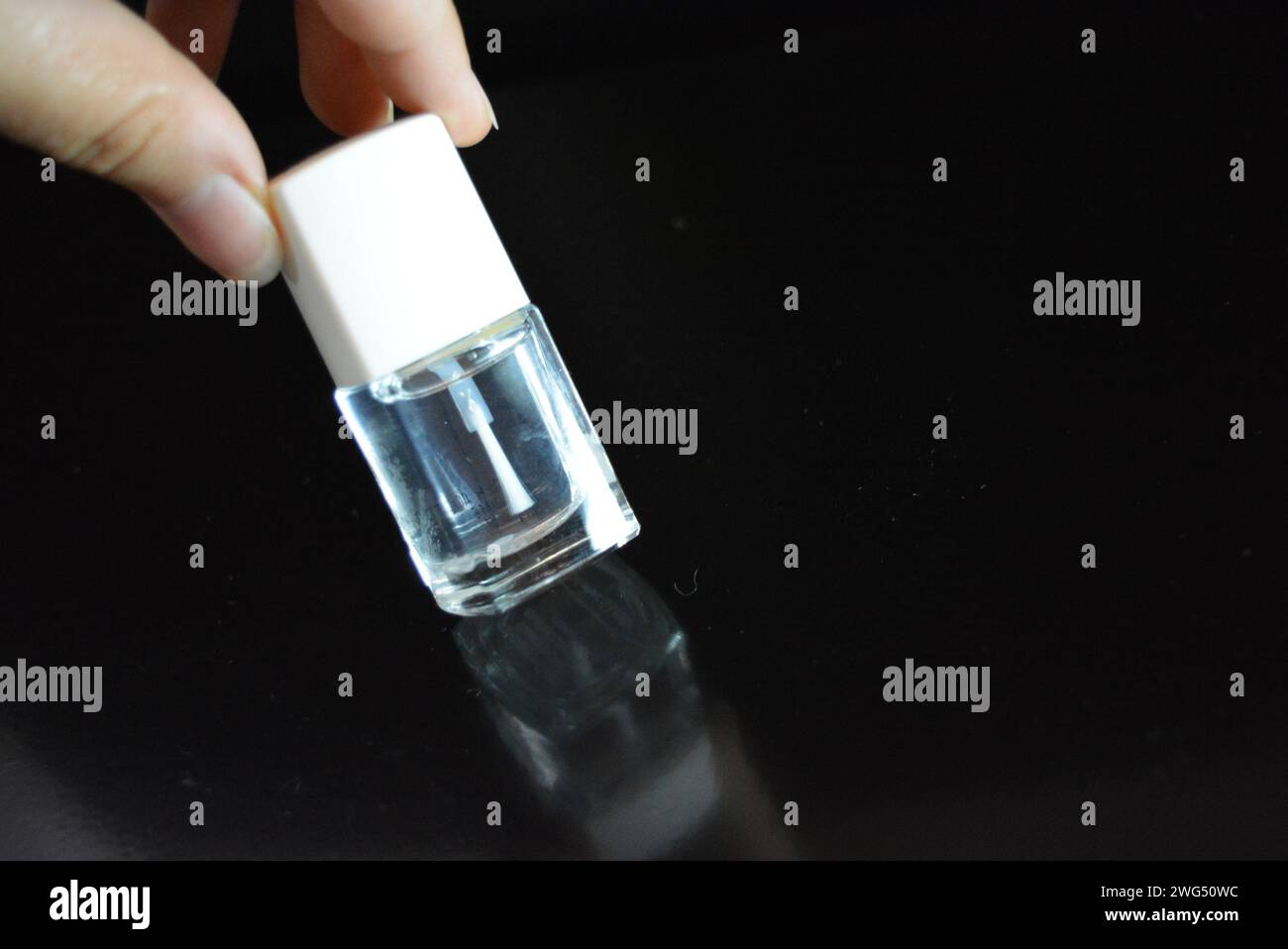 Female nail polish with a white lid for nail strengthening is located ...