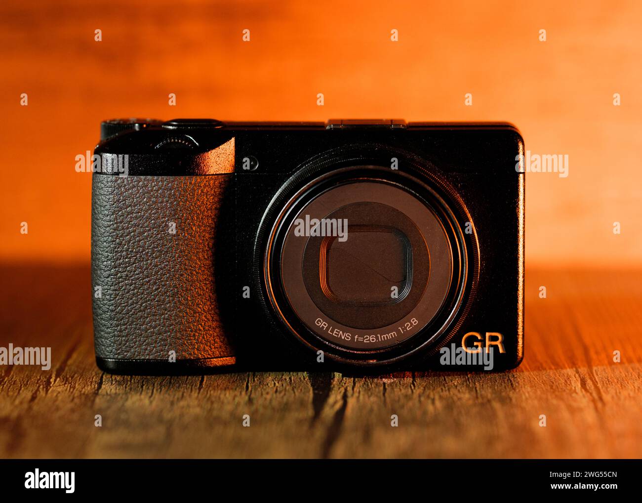 Ricoh GR III x is a compact 24MP APS-C format camera on wood bacground ...