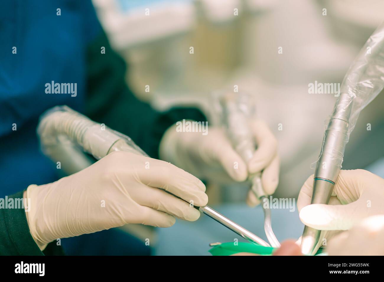 Detail of a dentist performing surgery with anesthesia on a patient for ...