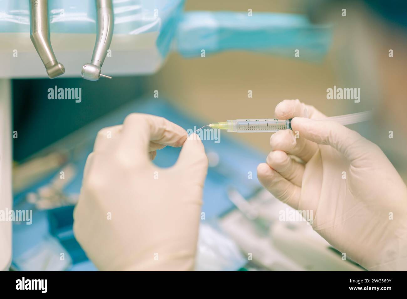 Detail of a dentist performing surgery with anesthesia on a patient for ...
