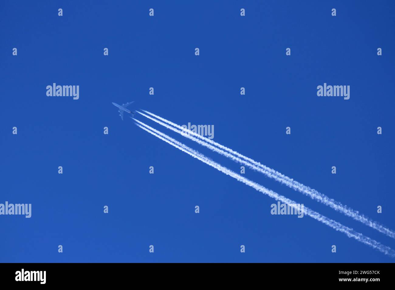 airplane in the blue sky, contrail Stock Photo - Alamy
