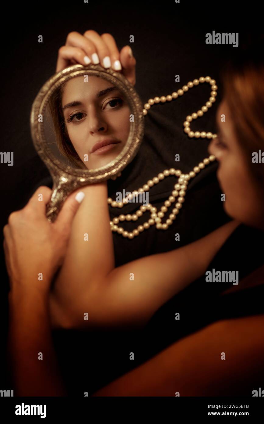 Woman holding hand mirror Stock Photo - Alamy