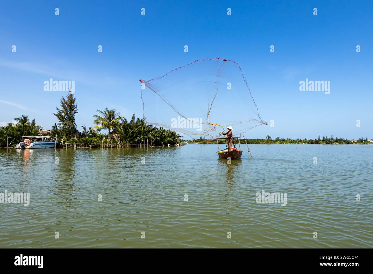 An old fisherman is throwing a net to catch fish Stock Photo - Alamy