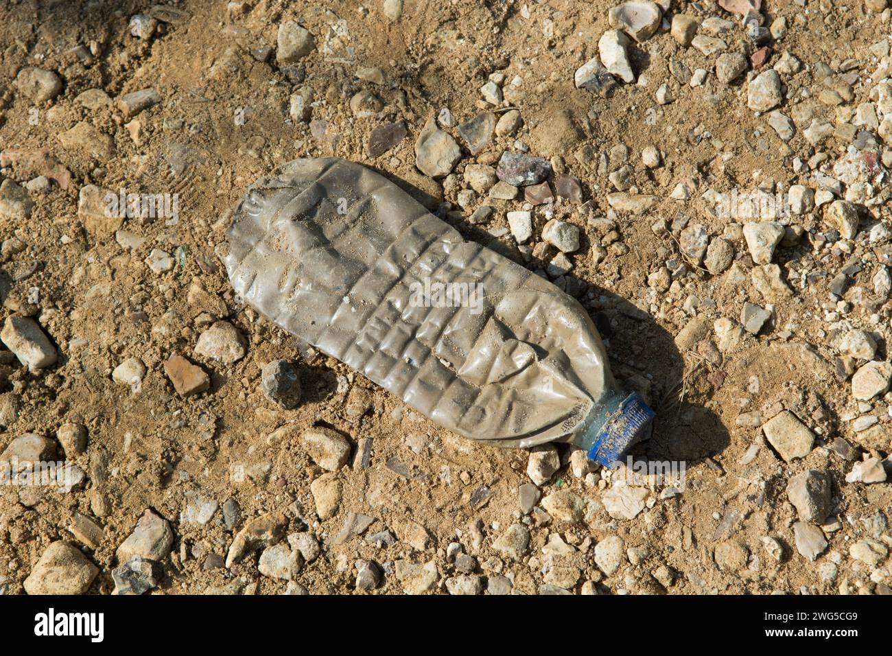 Old dirty plastic bottle on the ground Stock Photo - Alamy