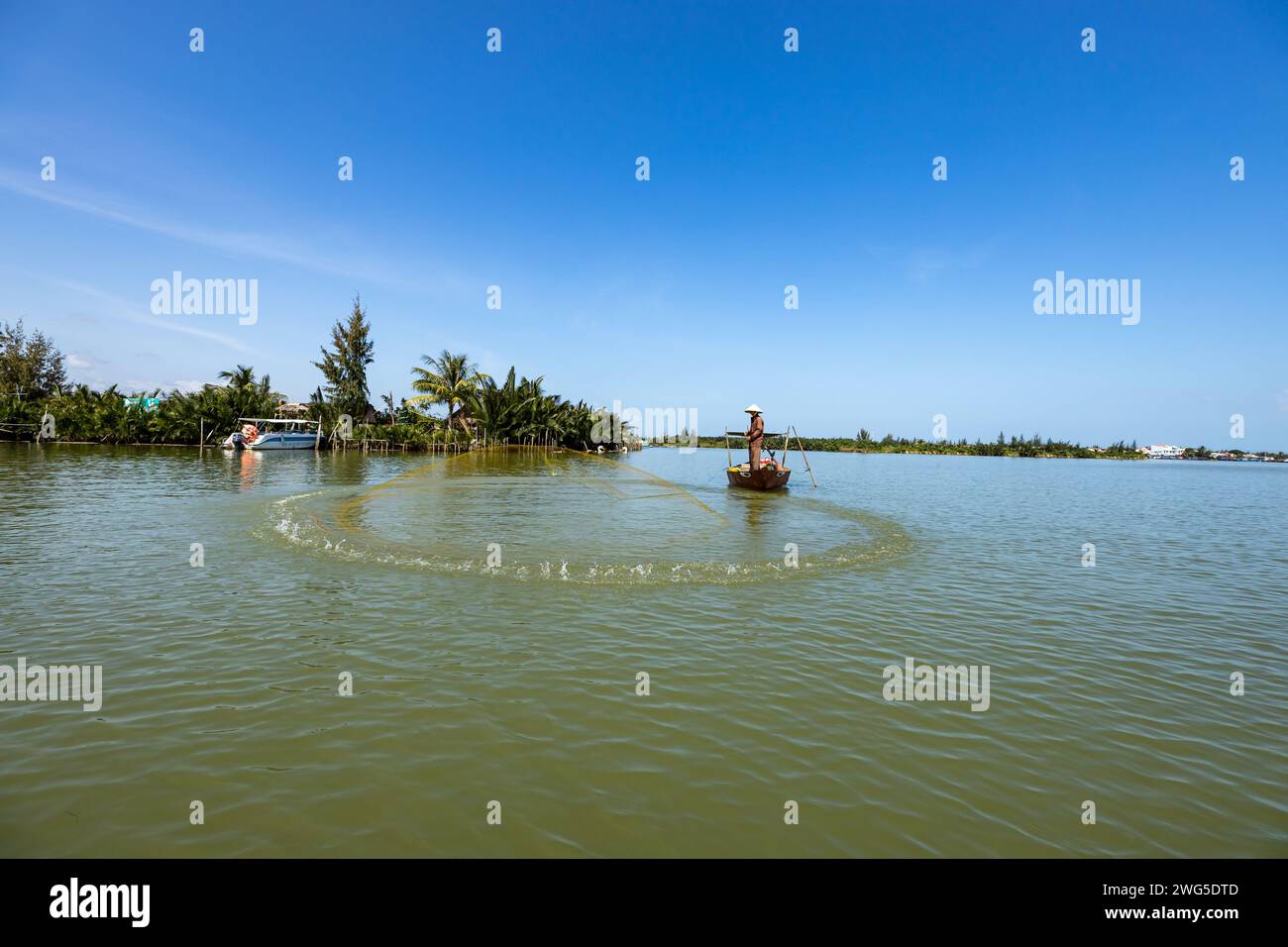 An old fisherman is throwing a net to catch fish Stock Photo - Alamy