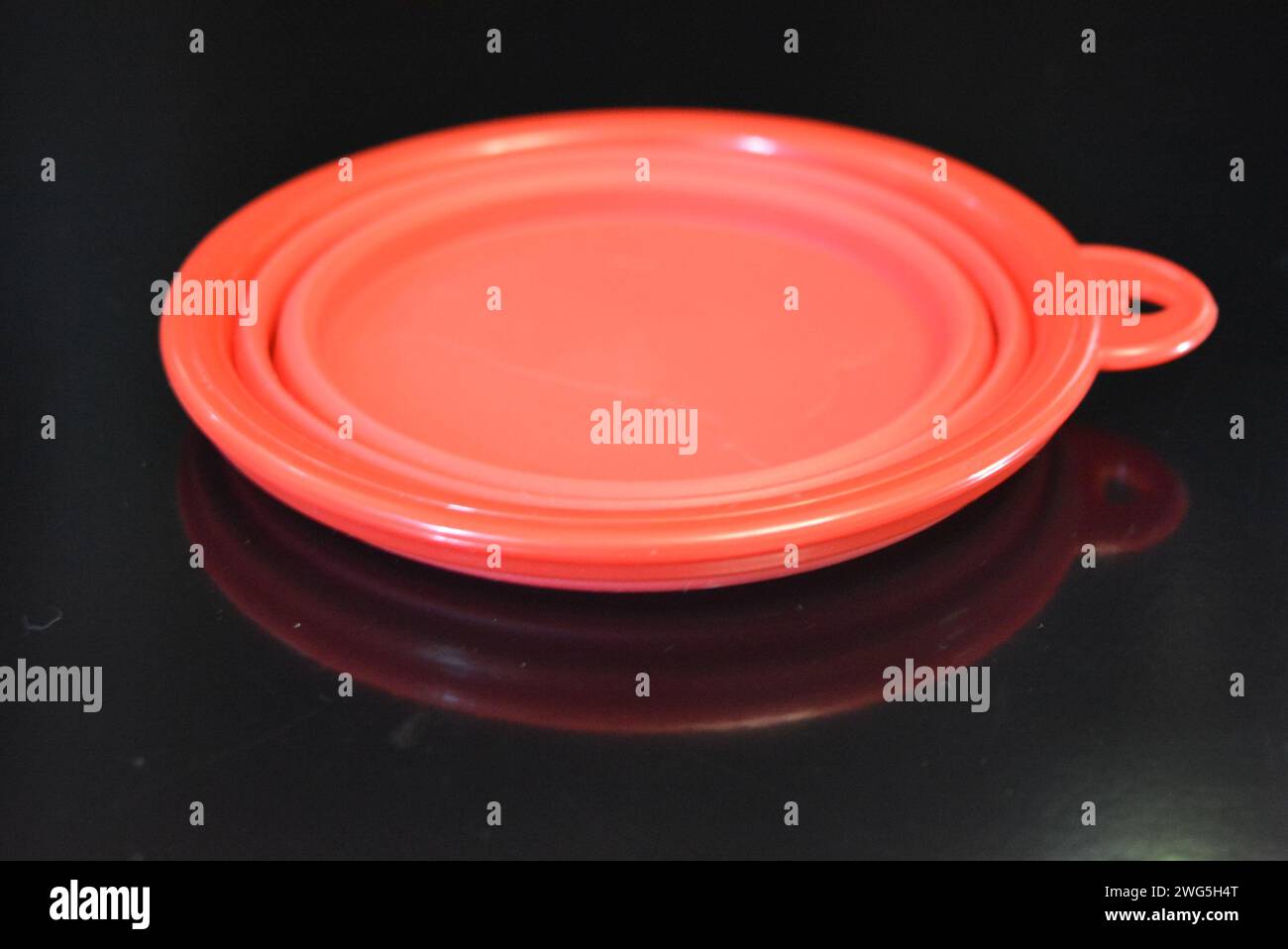 Red folding and multifunctional rubber plate, a bowl with a plastic ...