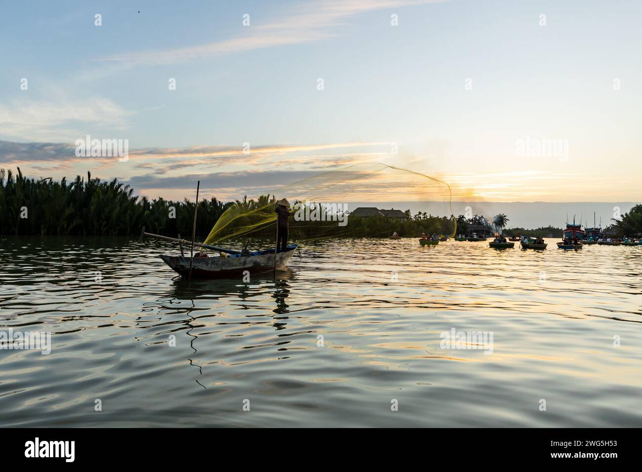 An old fisherman is throwing a net to catch fish Stock Photo - Alamy