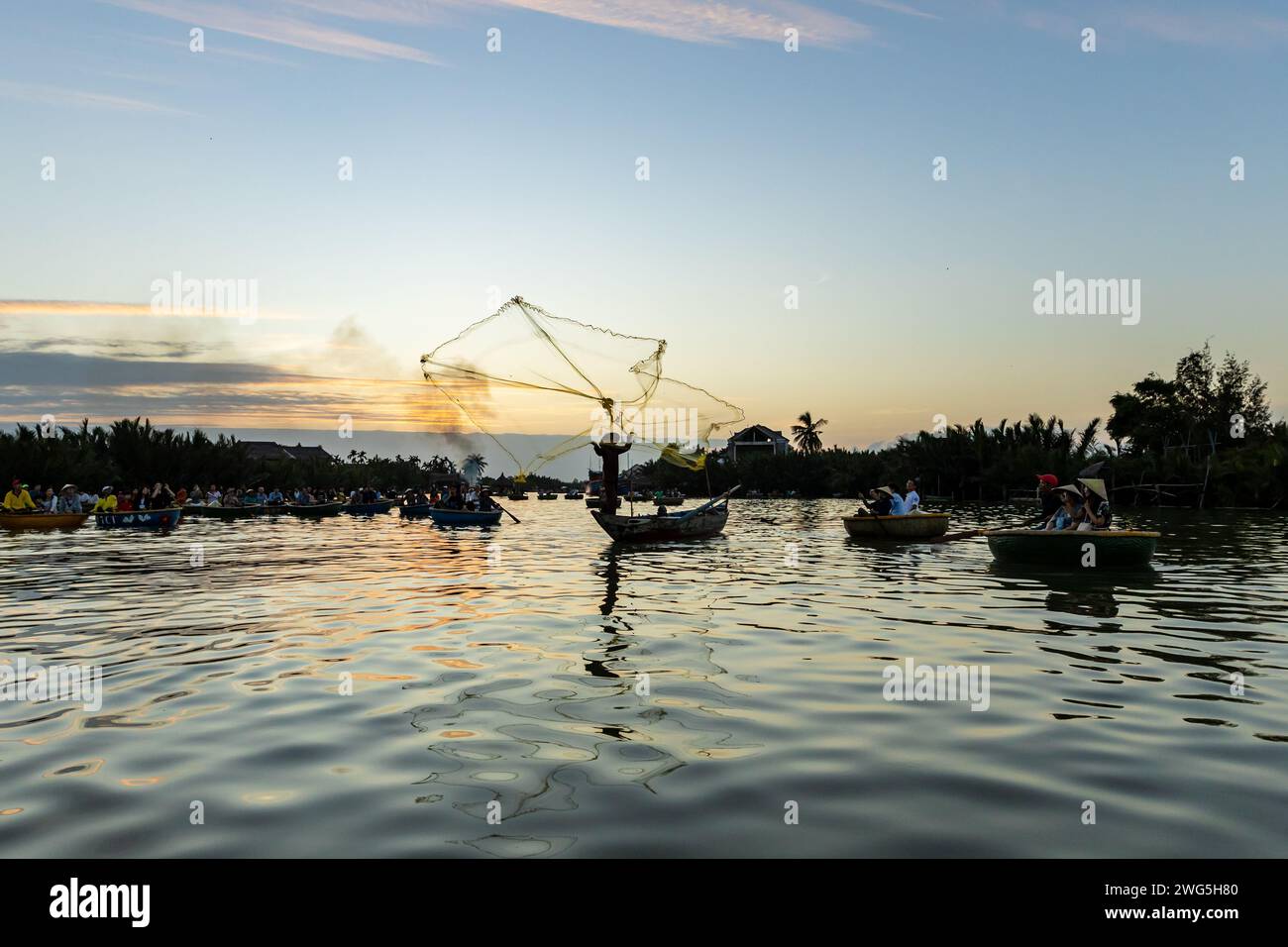 An old fisherman is throwing a net to catch fish Stock Photo - Alamy