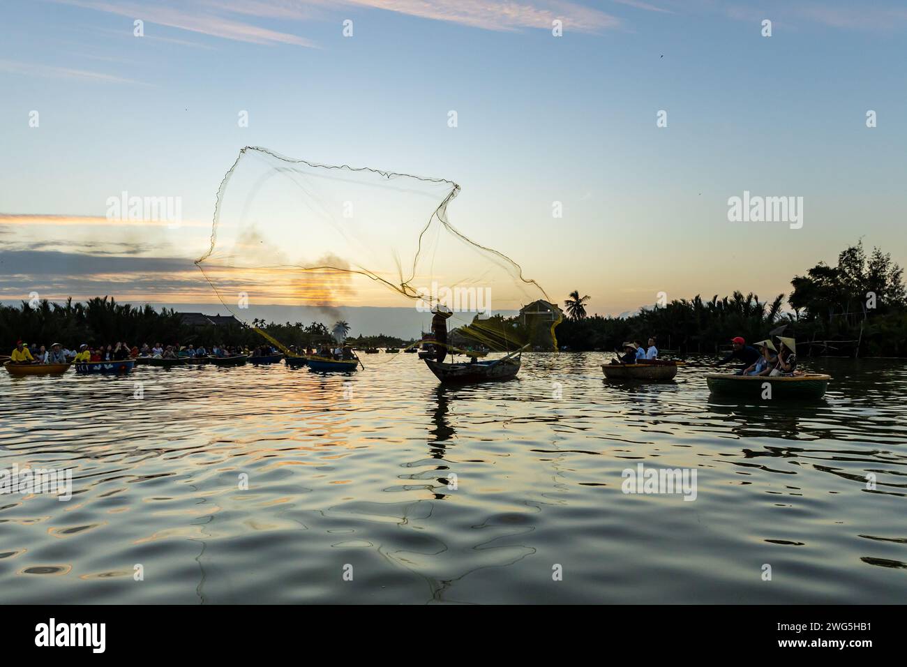 An old fisherman is throwing a net to catch fish Stock Photo - Alamy
