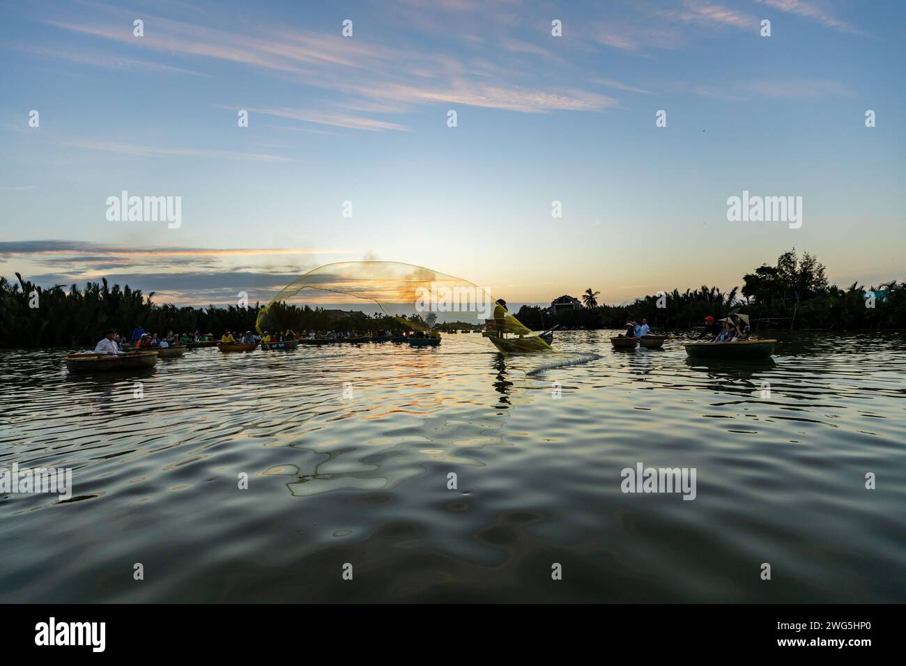 An old fisherman is throwing a net to catch fish Stock Photo - Alamy