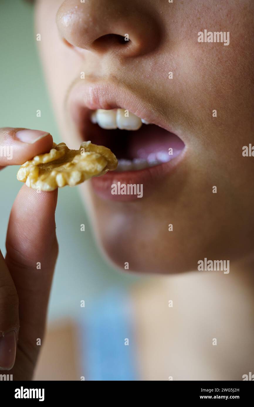 Crop anonymous teenage girl about to eat delicious walnut Stock Photo ...