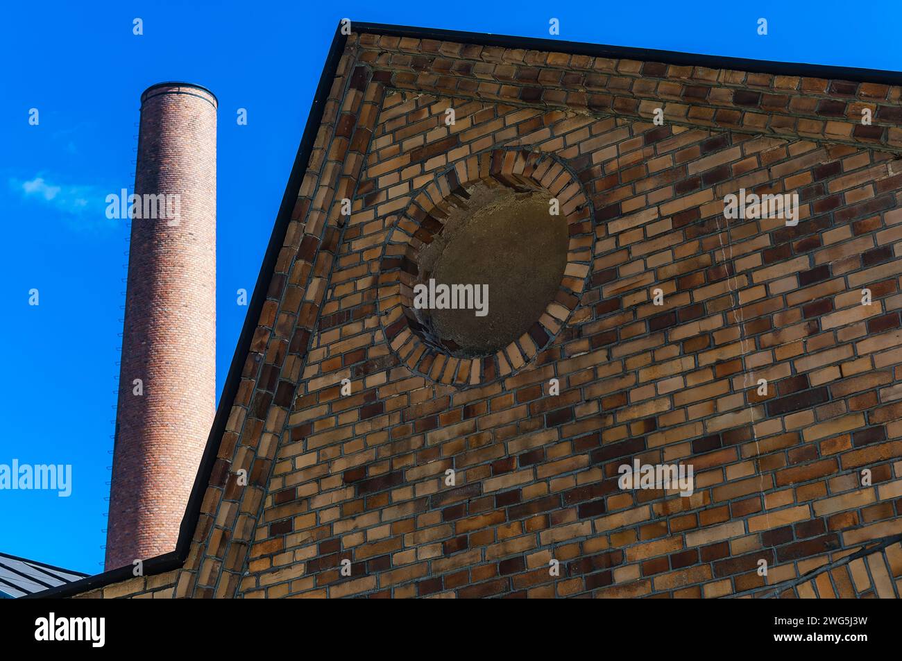 The image captures a segment of a vintage brick building featuring a ...