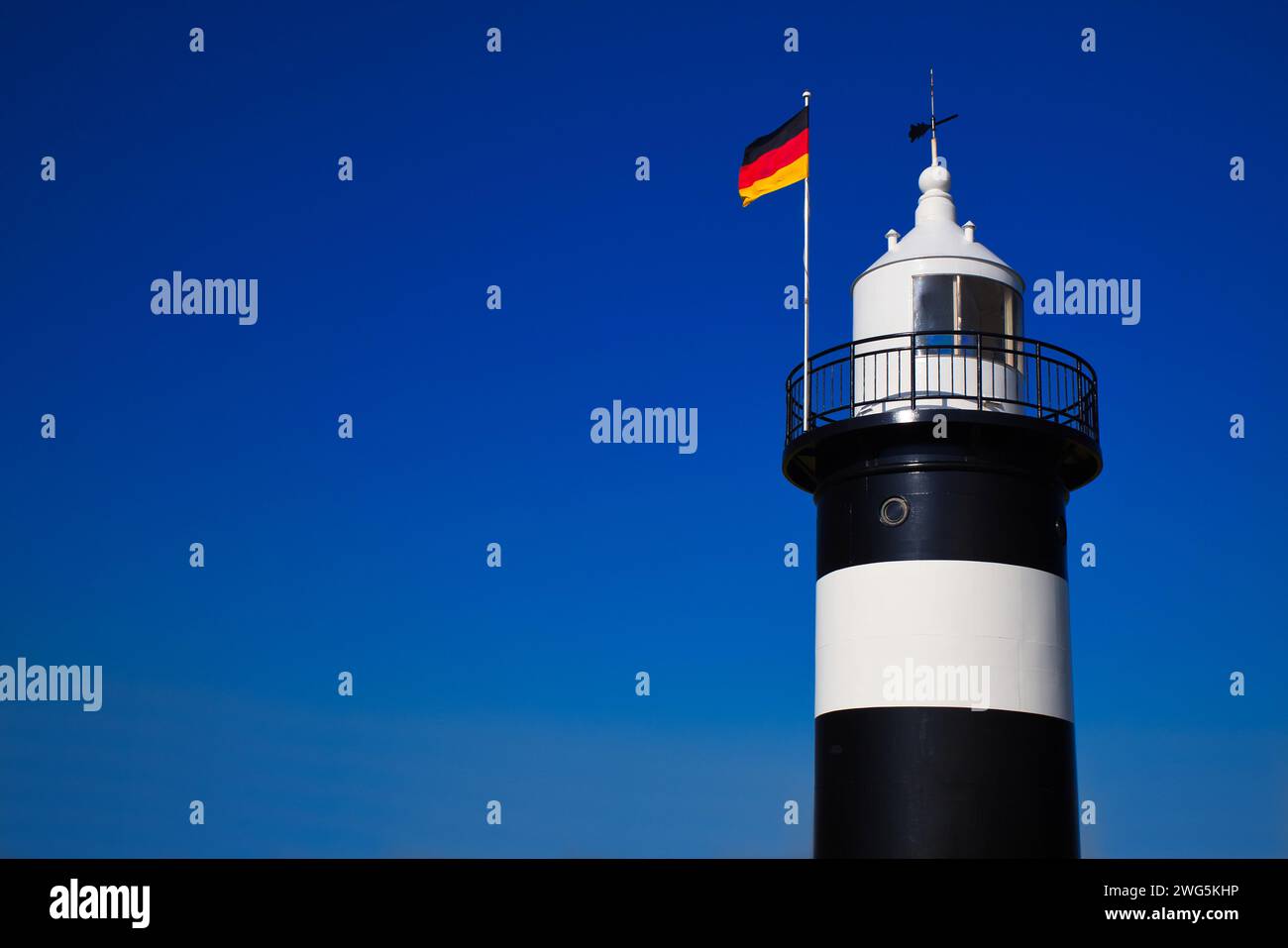 lighthouse with german flag and blue sky Stock Photo - Alamy