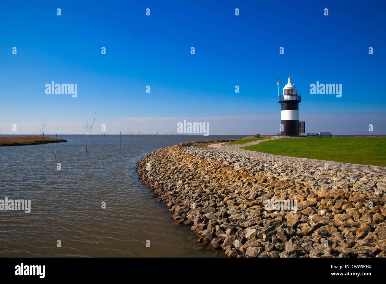 the little prussian lighthouse in wremen with dam and chanel and blue ...