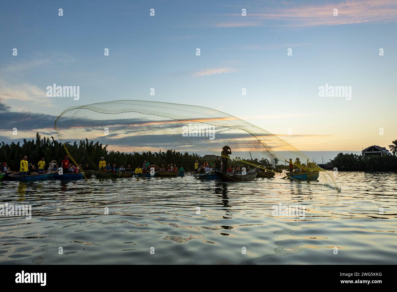 An old fisherman is throwing a net to catch fish Stock Photo - Alamy