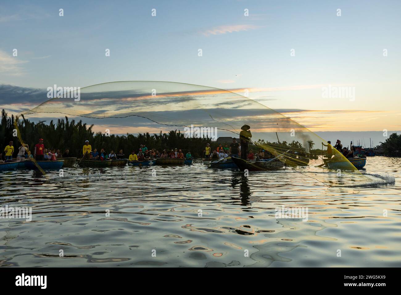 An old fisherman is throwing a net to catch fish Stock Photo - Alamy