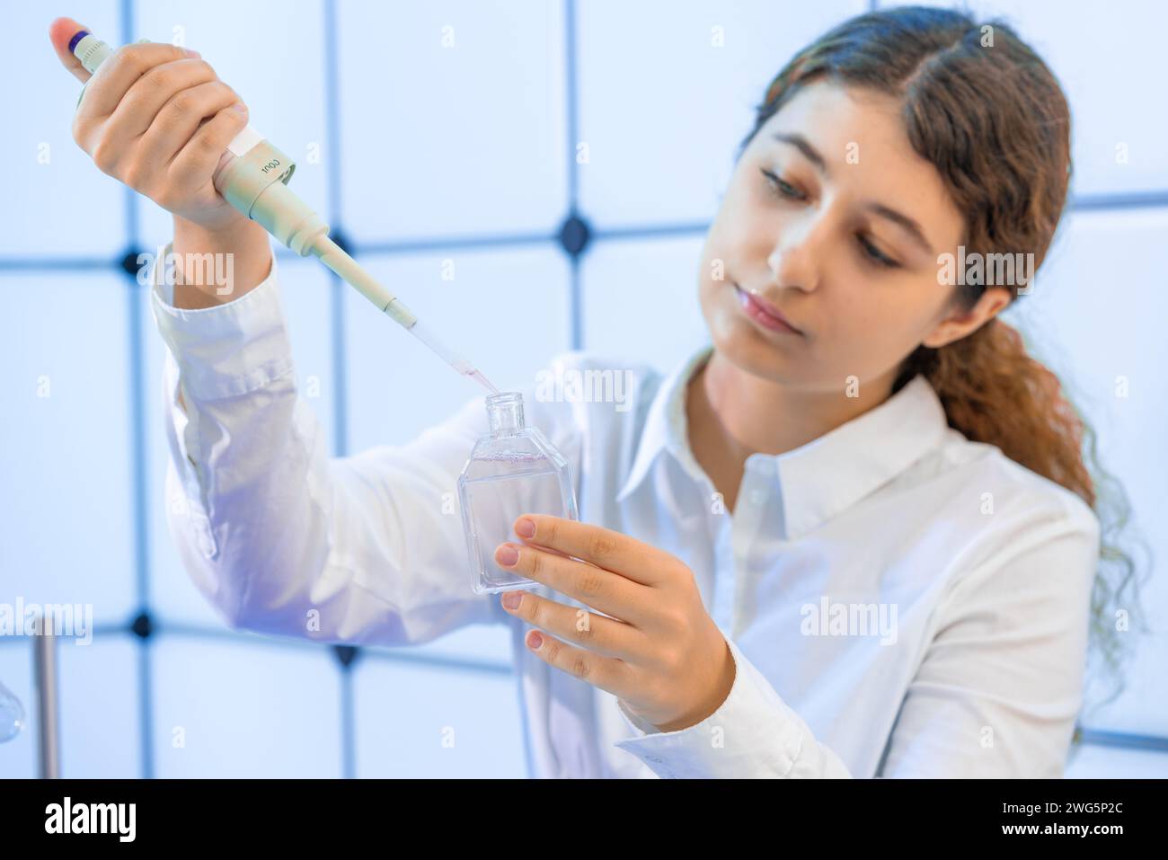 Female Scientist in Lab Coat Conducting Scientific Experiment in ...