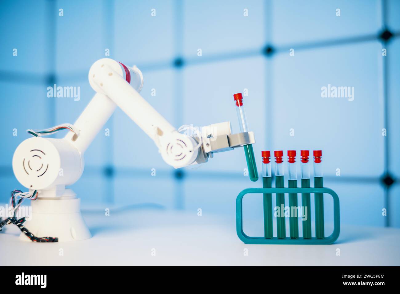 Experimental robot in a scientific laboratory manipulates test tubes ...