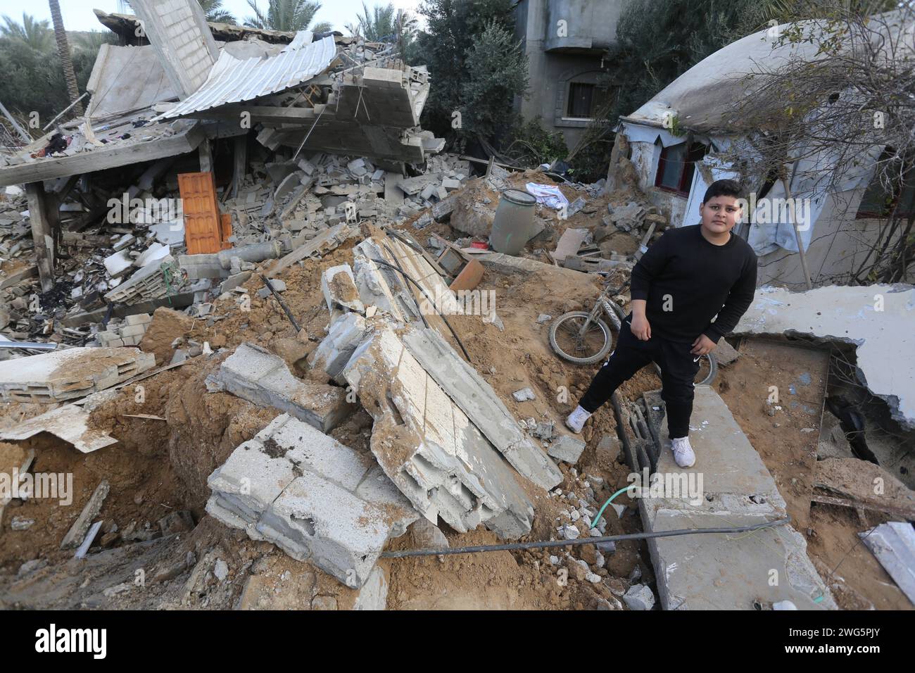 Palestinians inspect the damage in the buildings, after an overnight ...