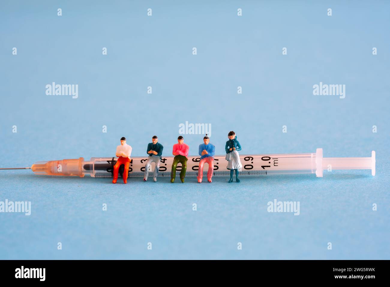 miniature figures of people sitting on a medical syringe Stock Photo ...