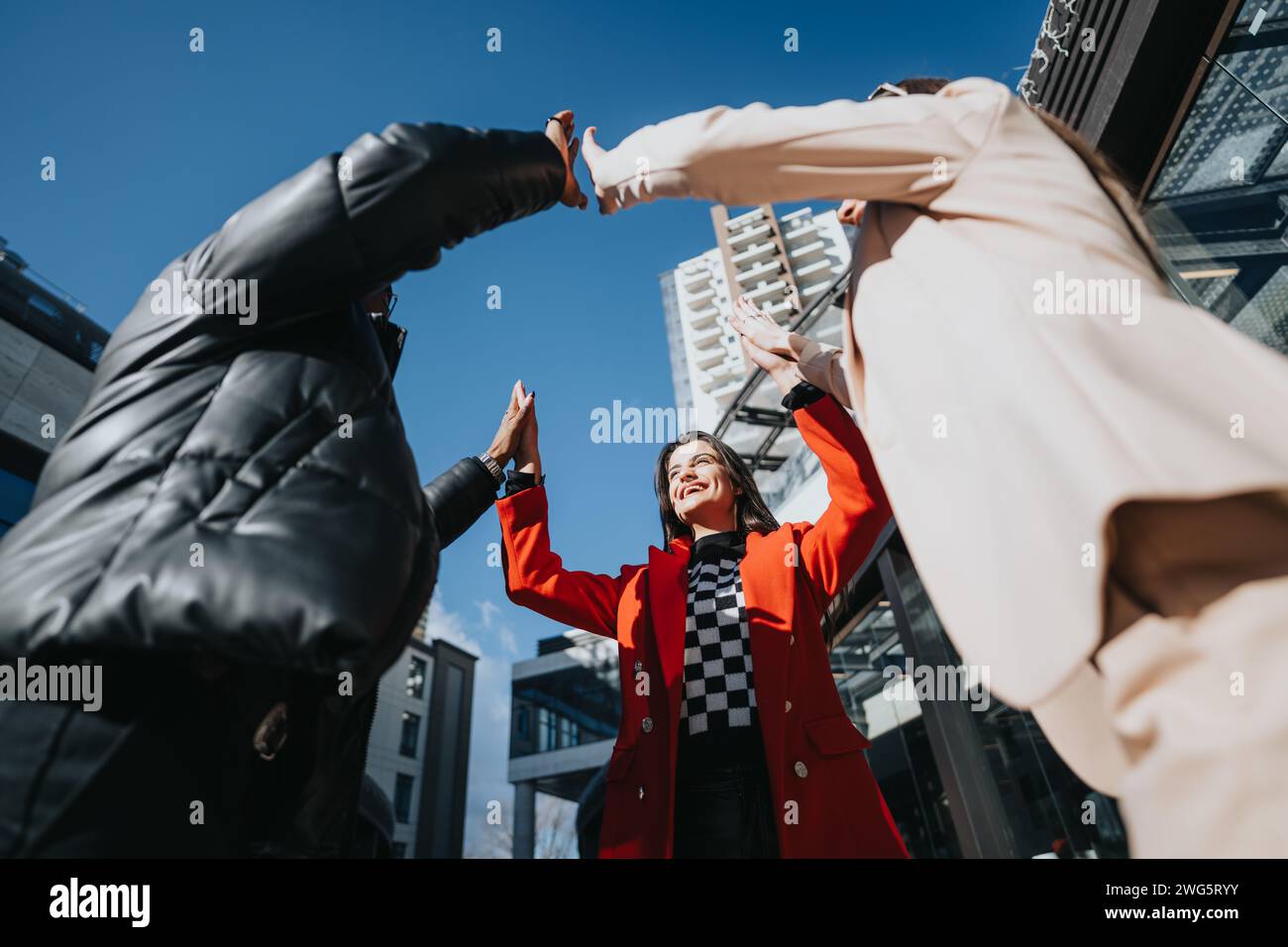 Cheerful female friends high fiving hi-res stock photography and images ...