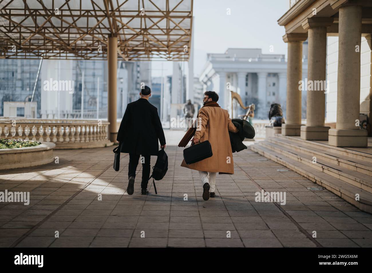Two business people walking together in modern city setting Stock Photo ...