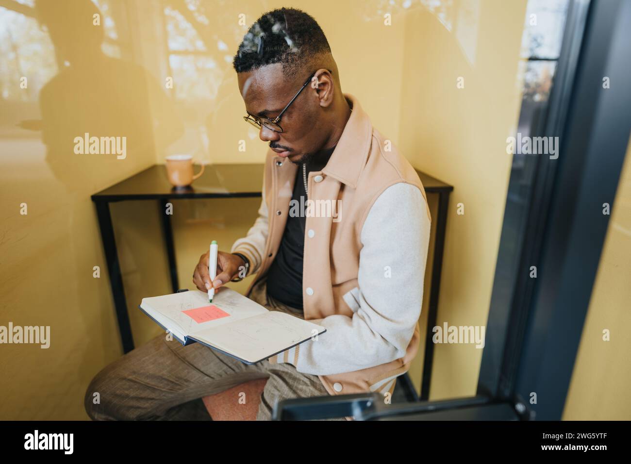 Confident African businessman analyzing sales statistics in the office ...
