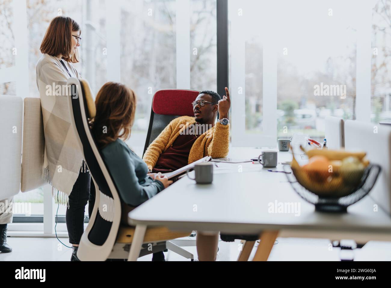 Successful diverse team of employees collaborating and discussing ...