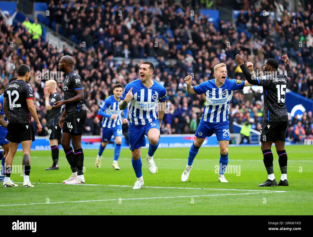 Brighton and Hove Albion's Lewis Dunk (centre) celebrates scoring their ...