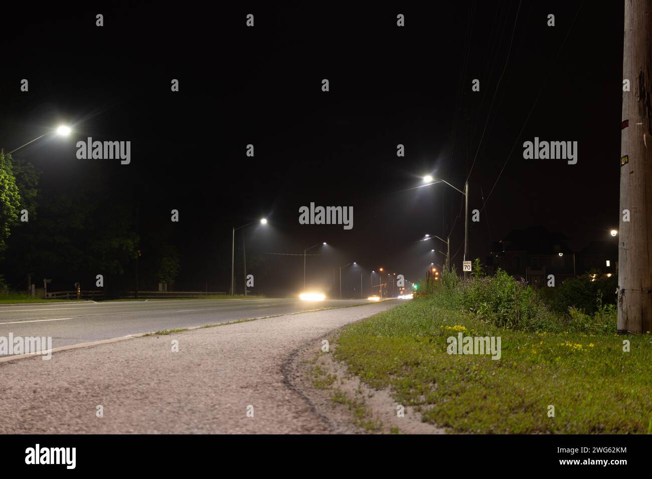 Nighttime cityscape - bright streetlights - red and white light trails ...