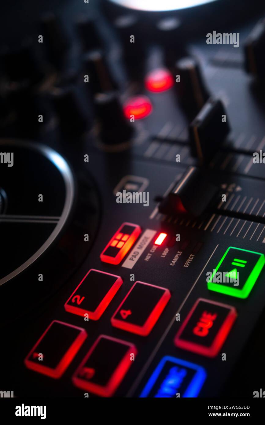 DJ mixing desk turntable in colored wedding disco party lights Stock ...