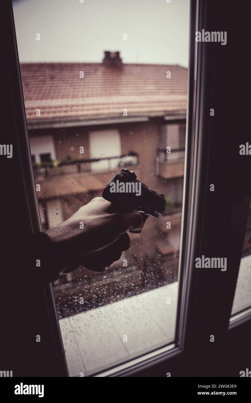 Gunman holding pistole in window dramatic photo book cover design Stock ...