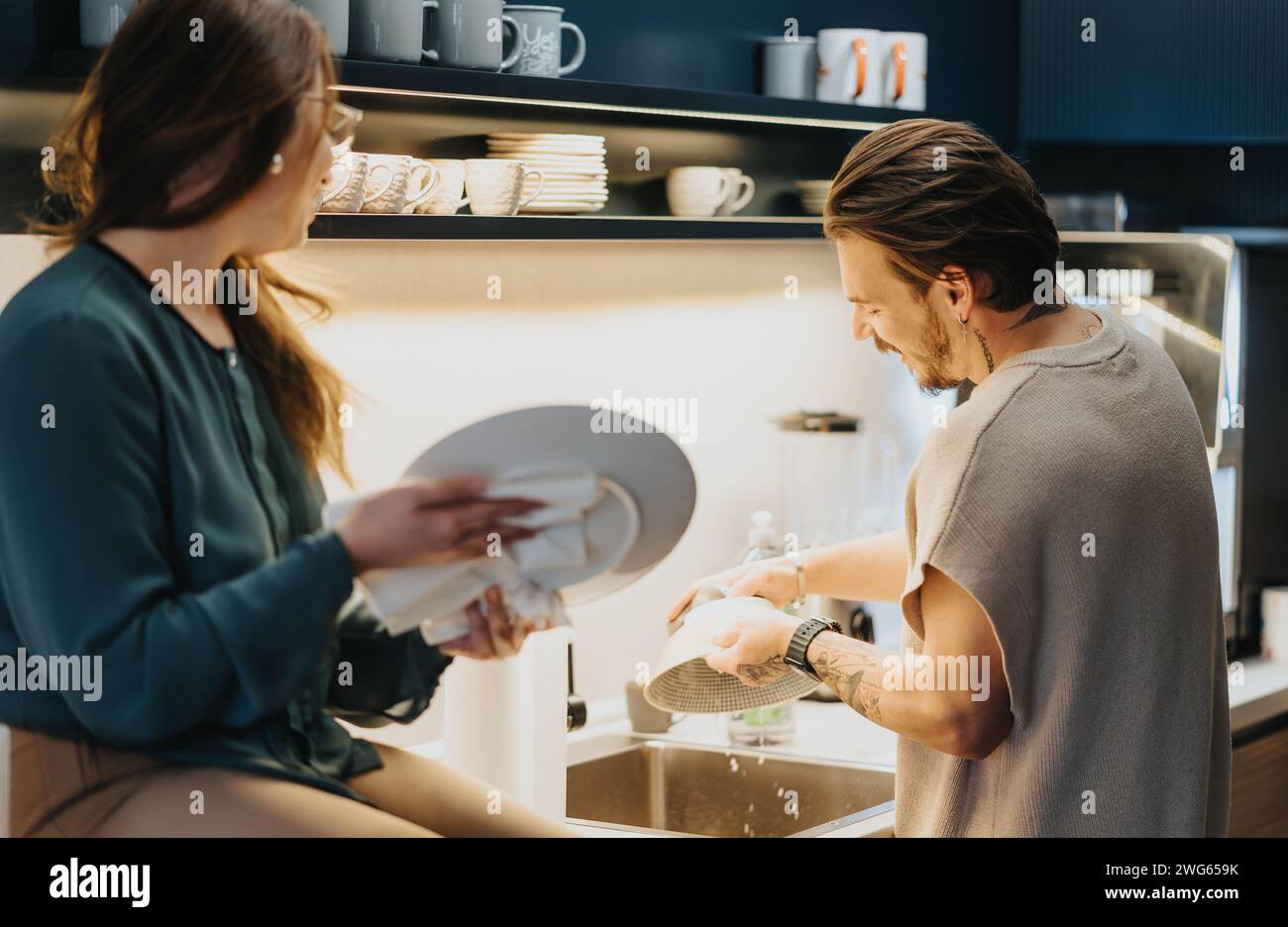 Colleagues enjoying a positive atmosphere in the office kitchen ...