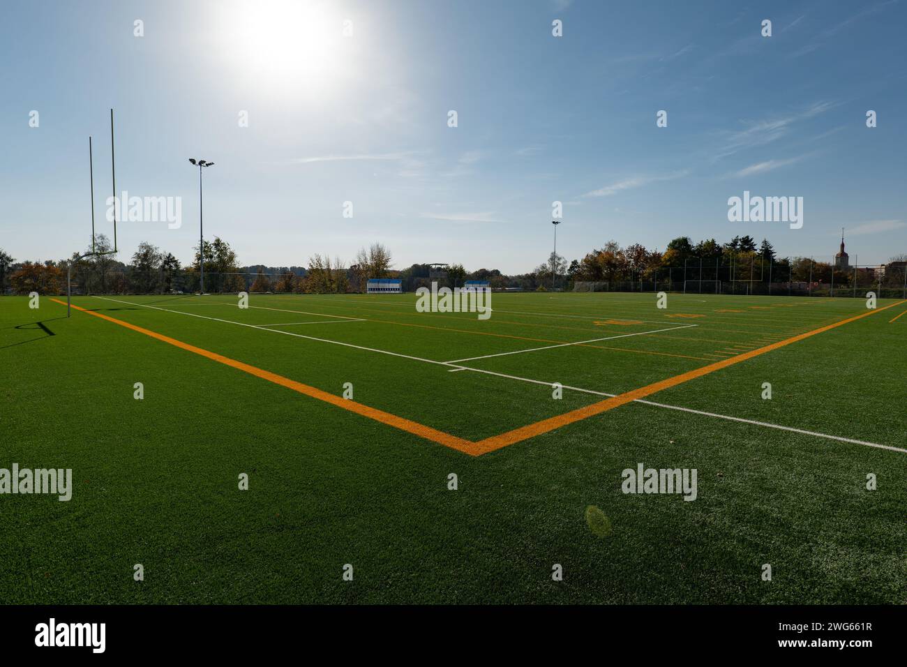 Brand new football pitch with yellow lines and blue skyat sunset Stock ...