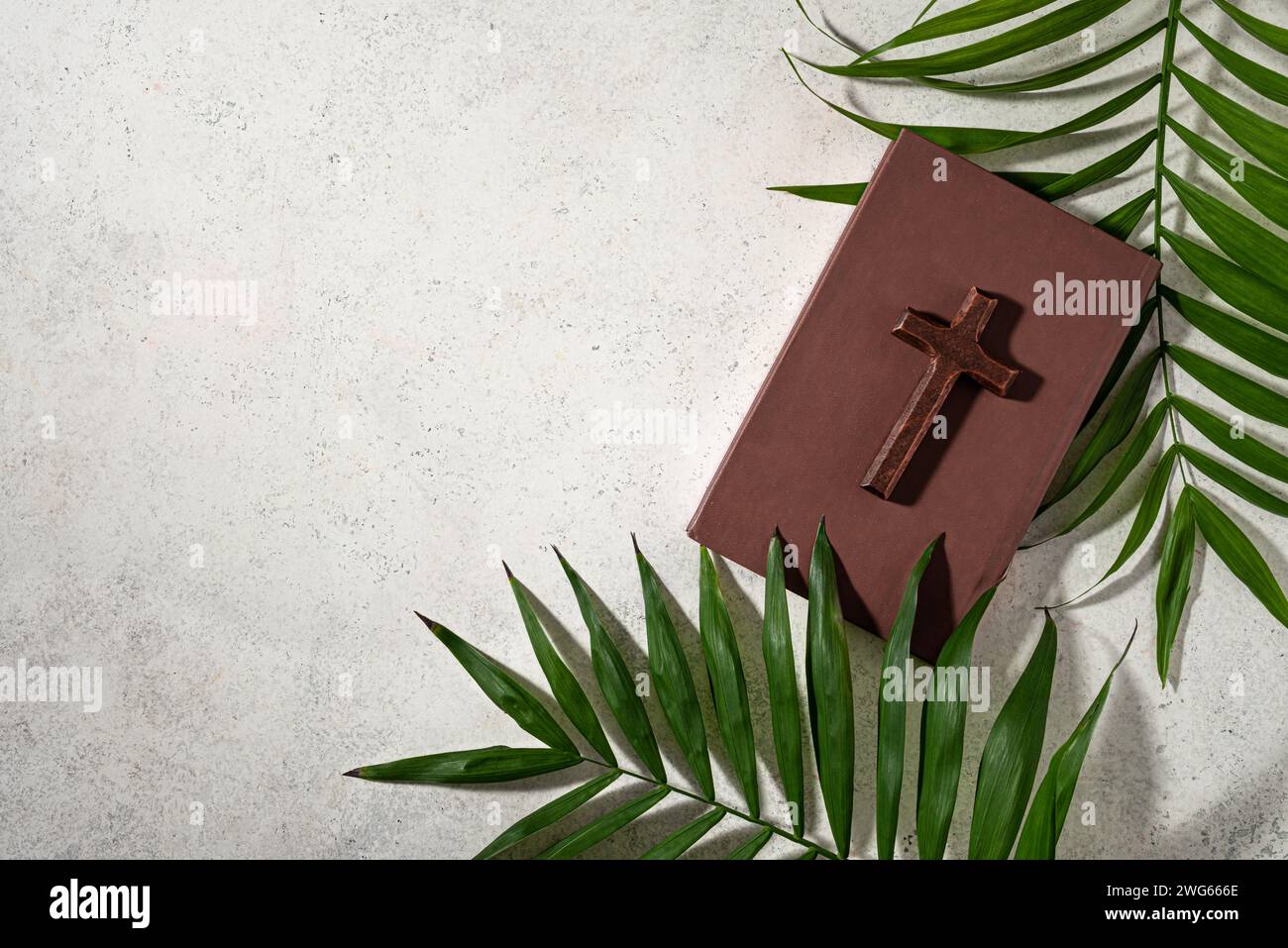 Palm Sunday. Wooden christian cross, holy bible book and palm leaves ...