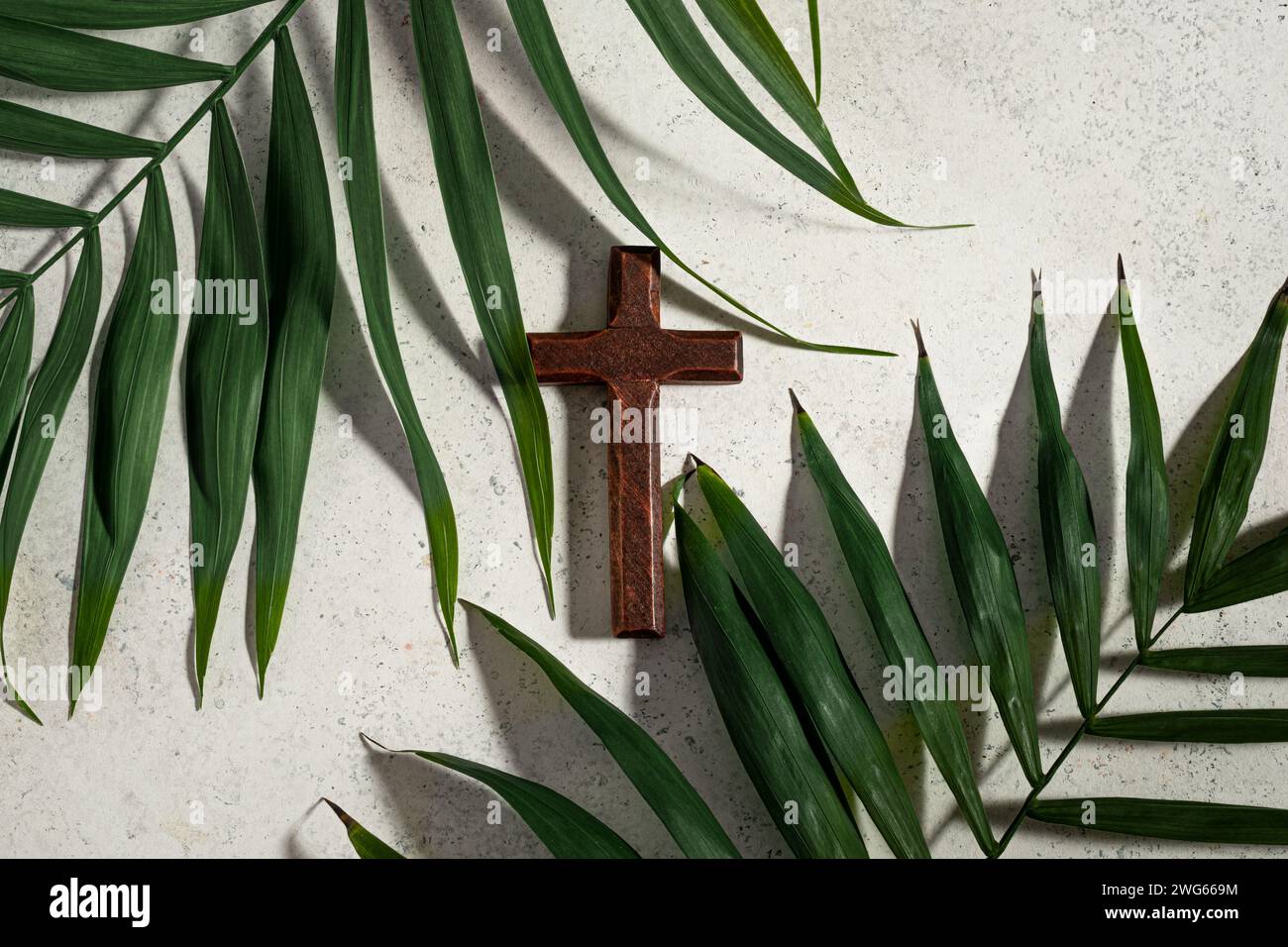 Palm Sunday. Wooden christian cross and palm leaves, top view. Palm ...