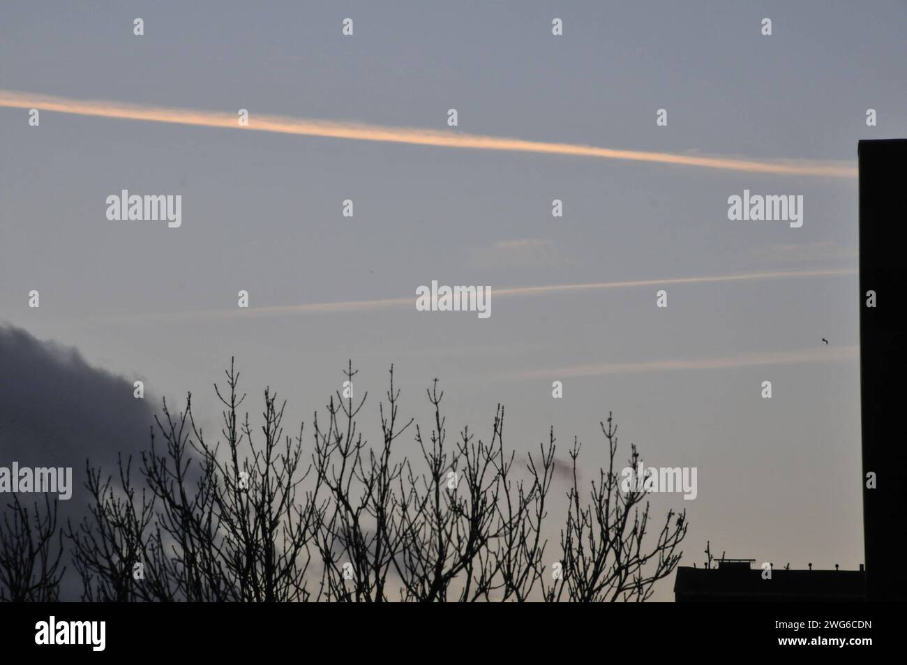 Copenhagen, Denmark /03 February 2024/. Flights smke lines over Ksstrup ...