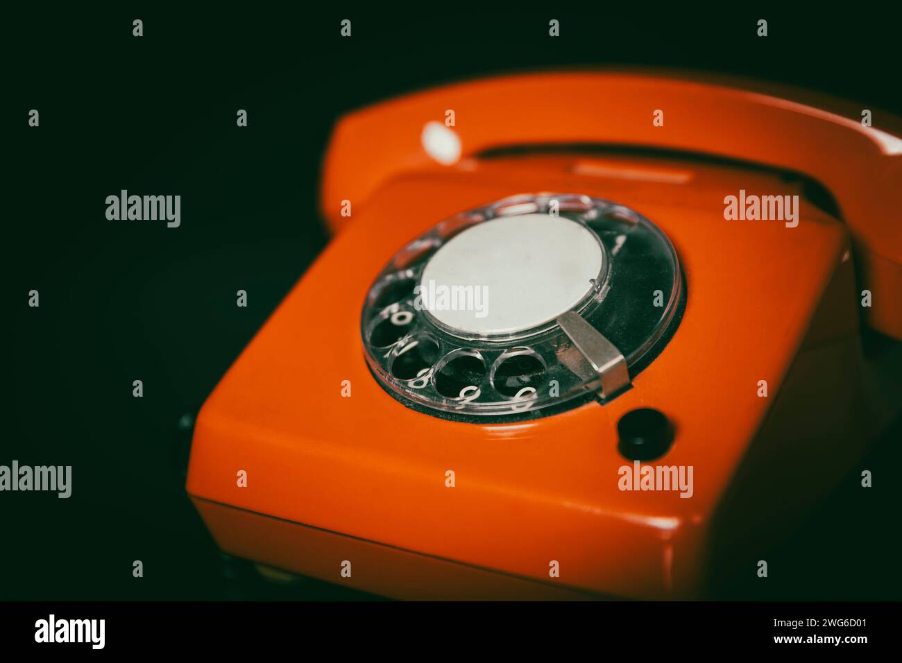 An old red telephone with a rotary dial, an old historical red ...