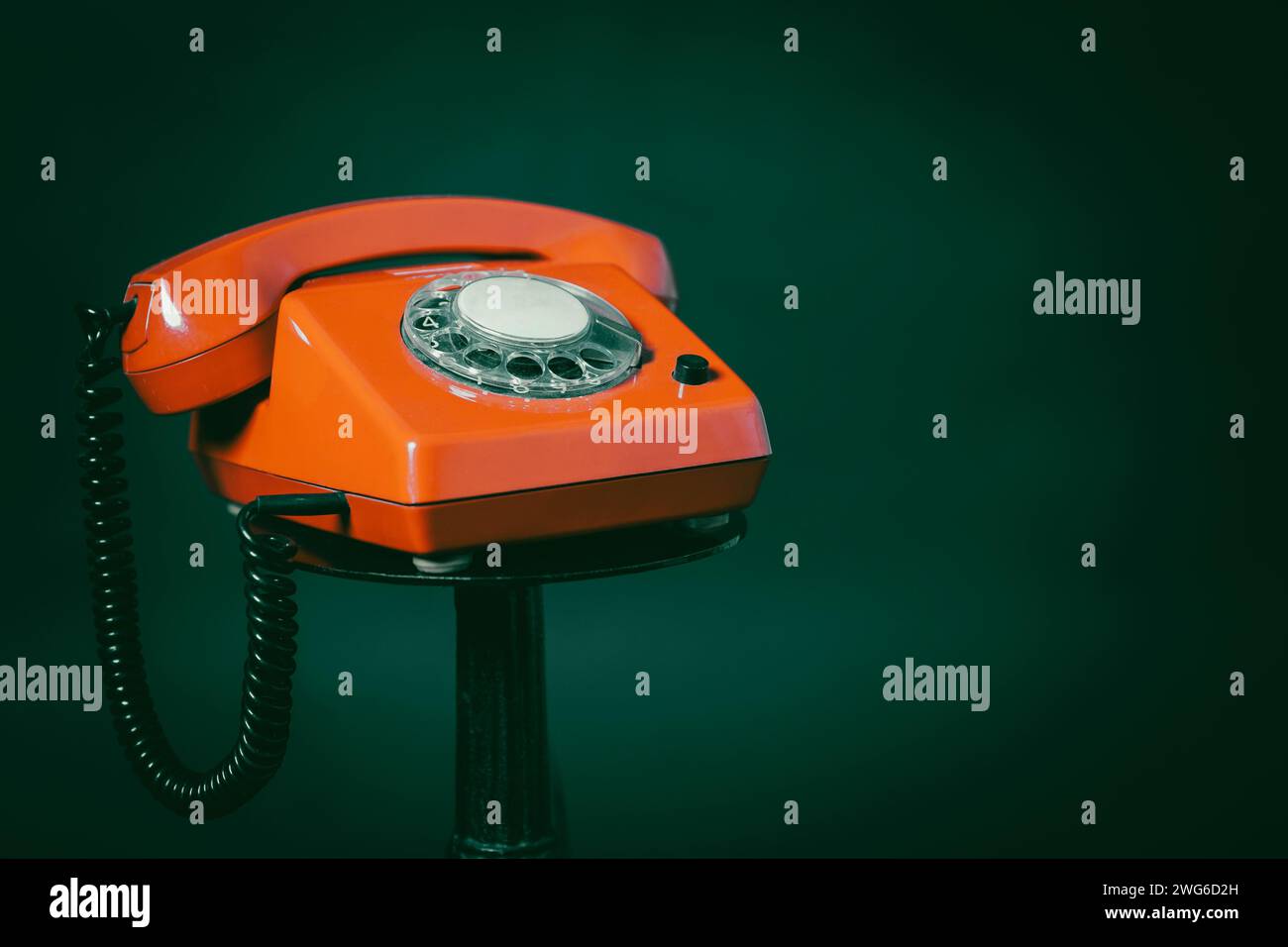 An old red telephone with a rotary dial, an old historical red ...
