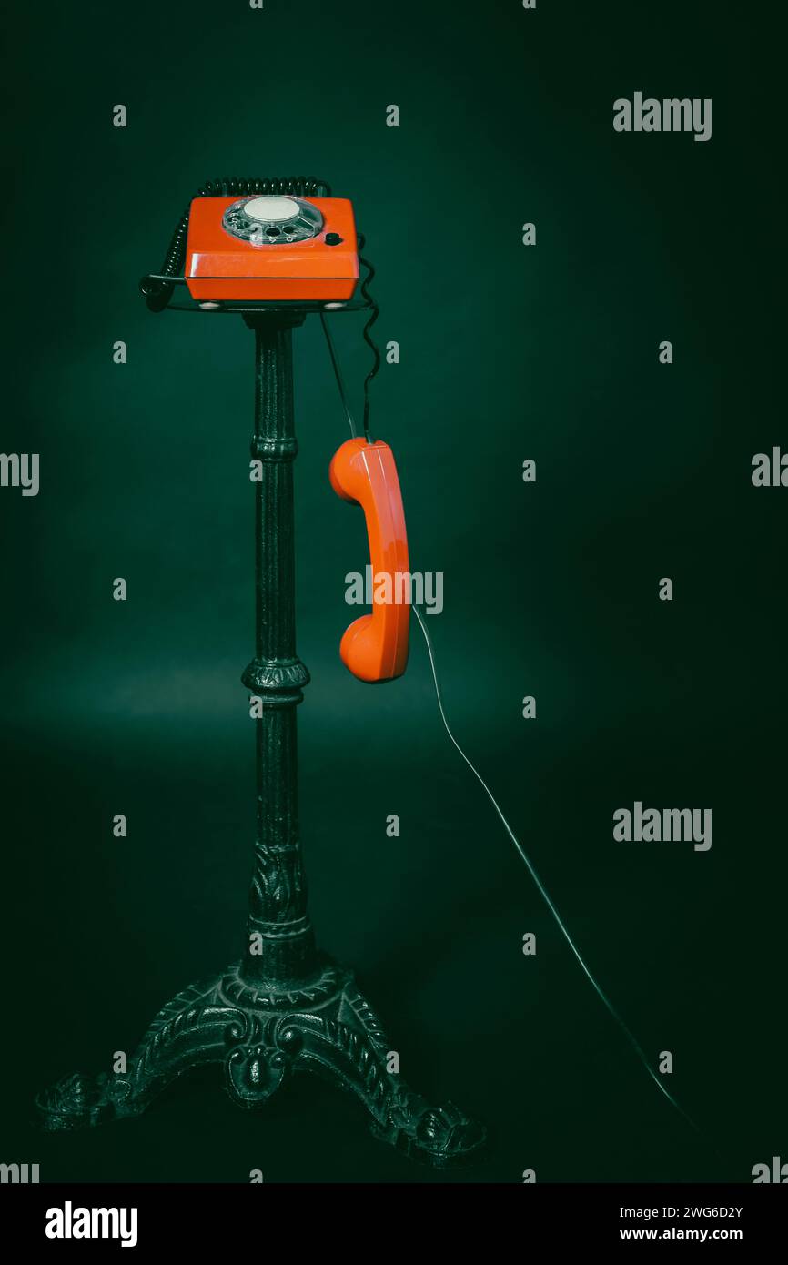 An old red telephone with a rotary dial, an old historical red ...