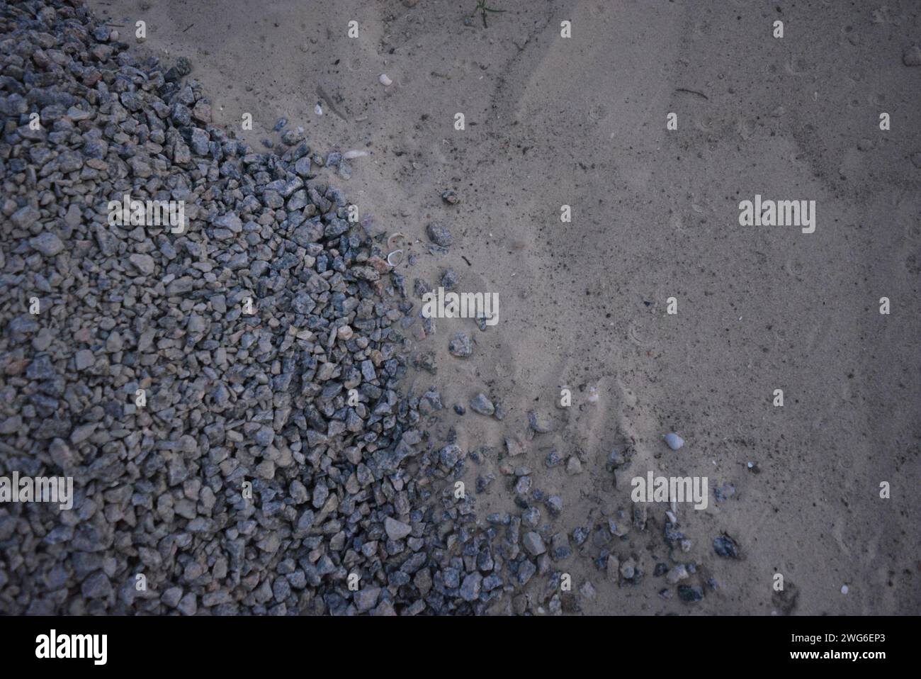 Pile of construction pebbles for concreting and pile of white river ...