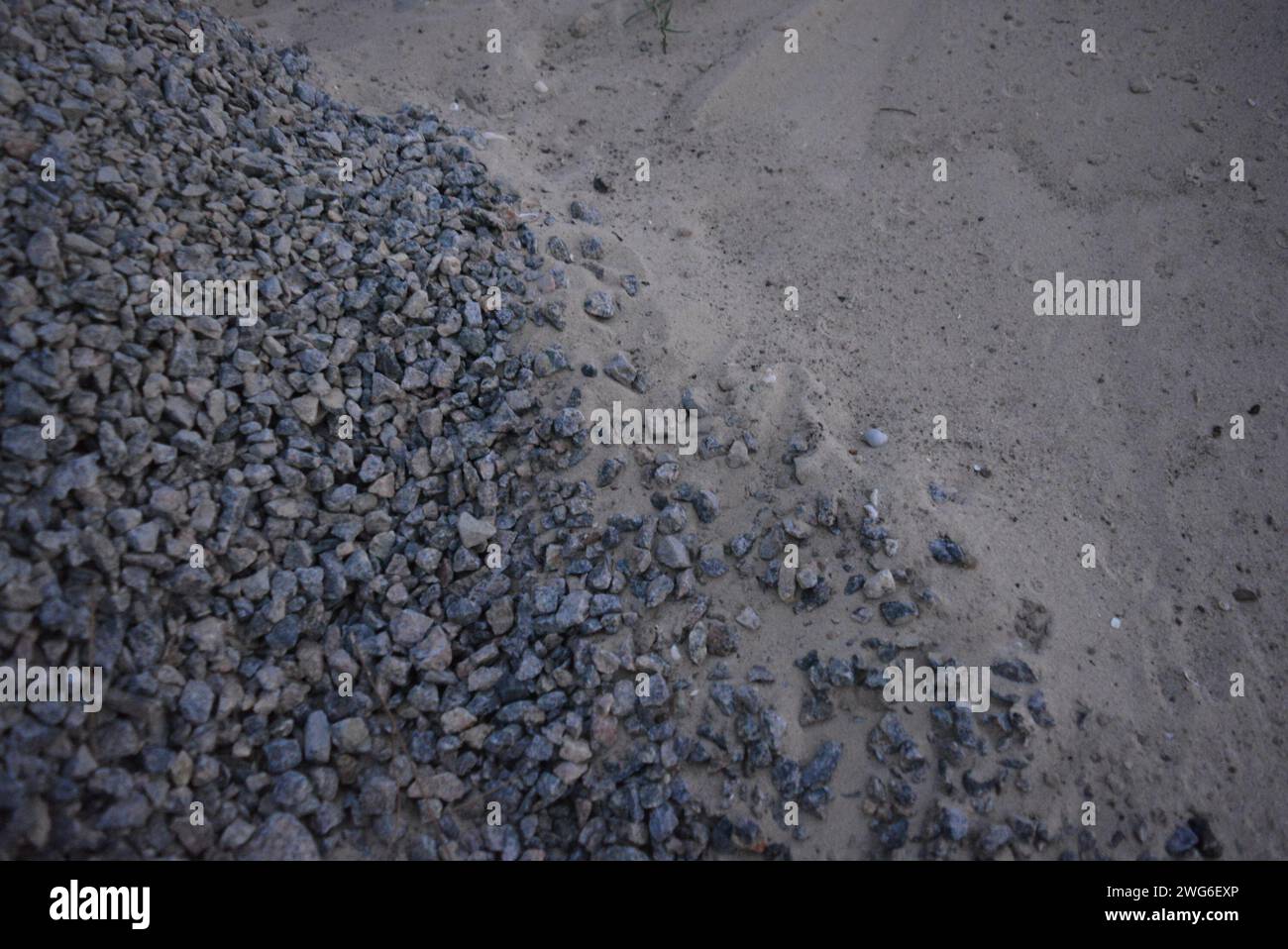 Pile of construction pebbles for concreting and pile of white river ...