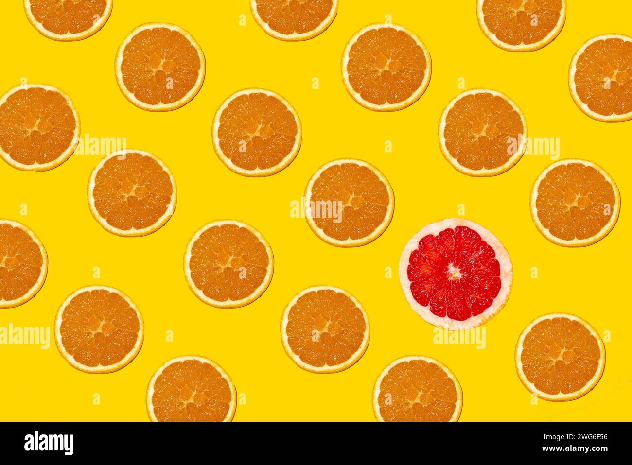 Pattern of orange slices with a red grapefruit slice breaking through ...