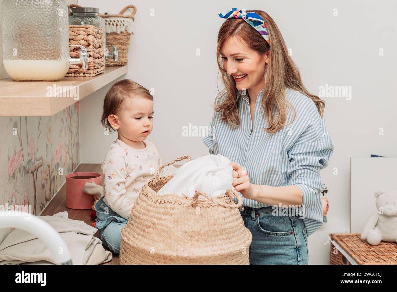 Mom showing her daughter clean washed clothes Stock Photo - Alamy