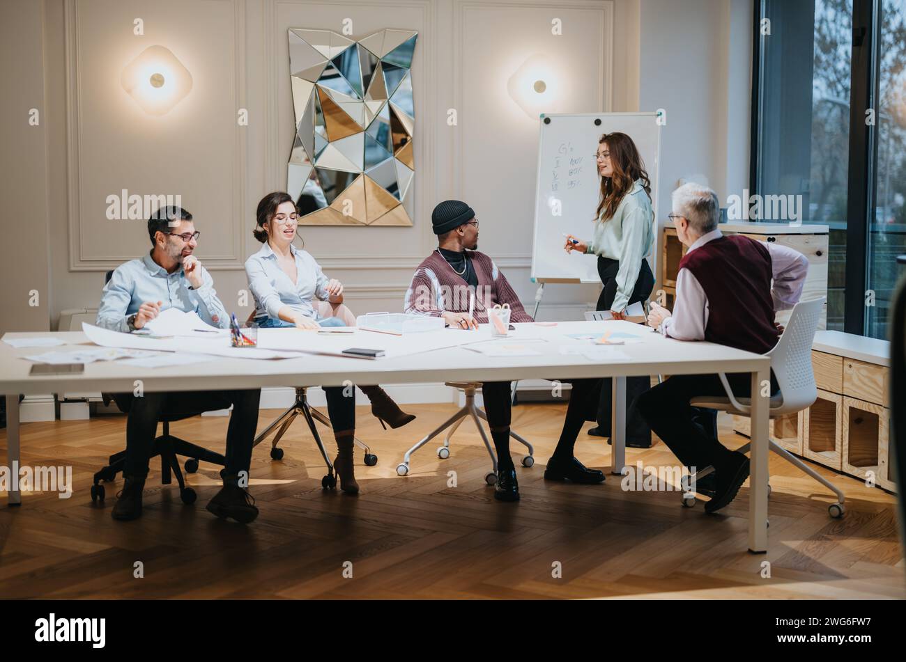 Multiracial colleagues engaged in a strategic meeting in a modern ...